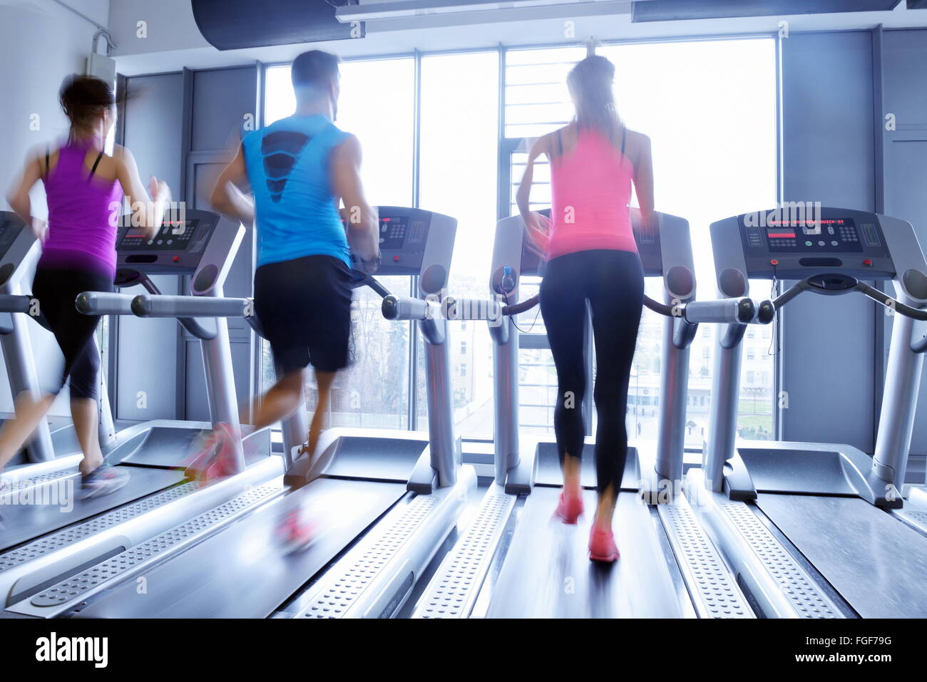Group of people running on treadmills Stock Photo - Alamy