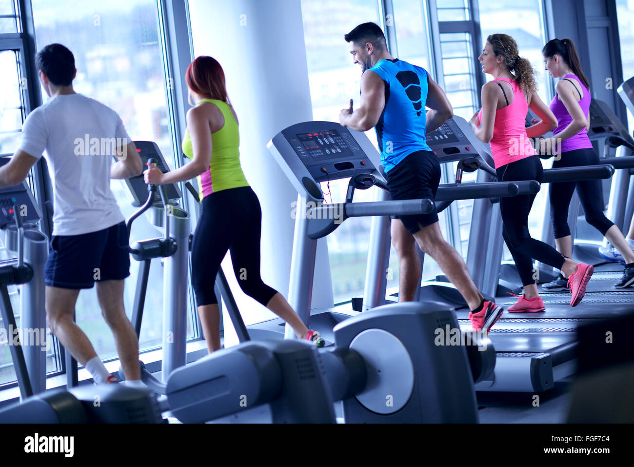Group of people running on treadmills Stock Photo - Alamy