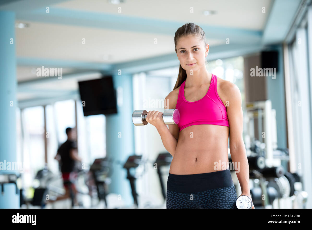 lifting some weights and working on her biceps in a gym Stock Photo - Alamy