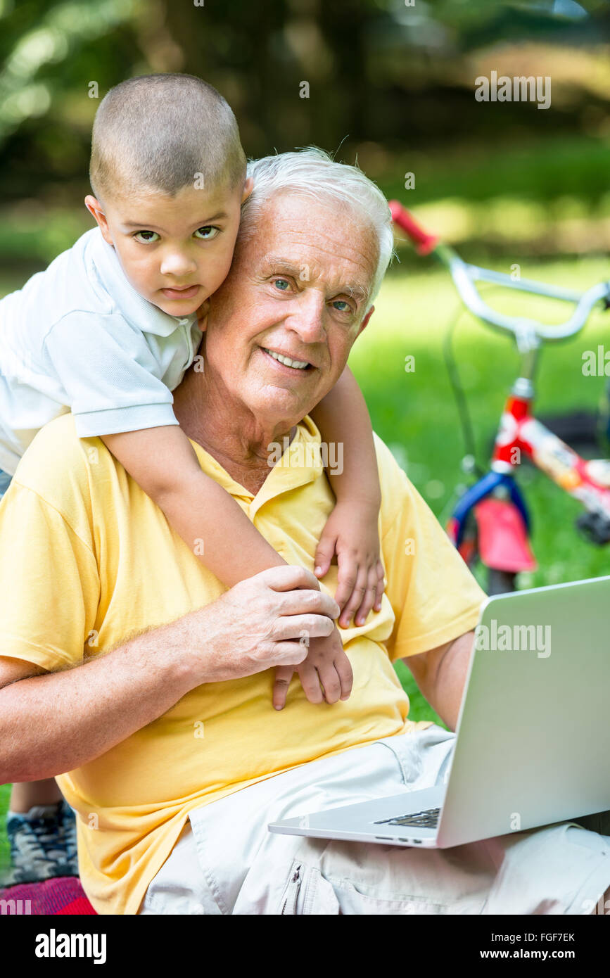 grandfather and child using laptop Stock Photo - Alamy