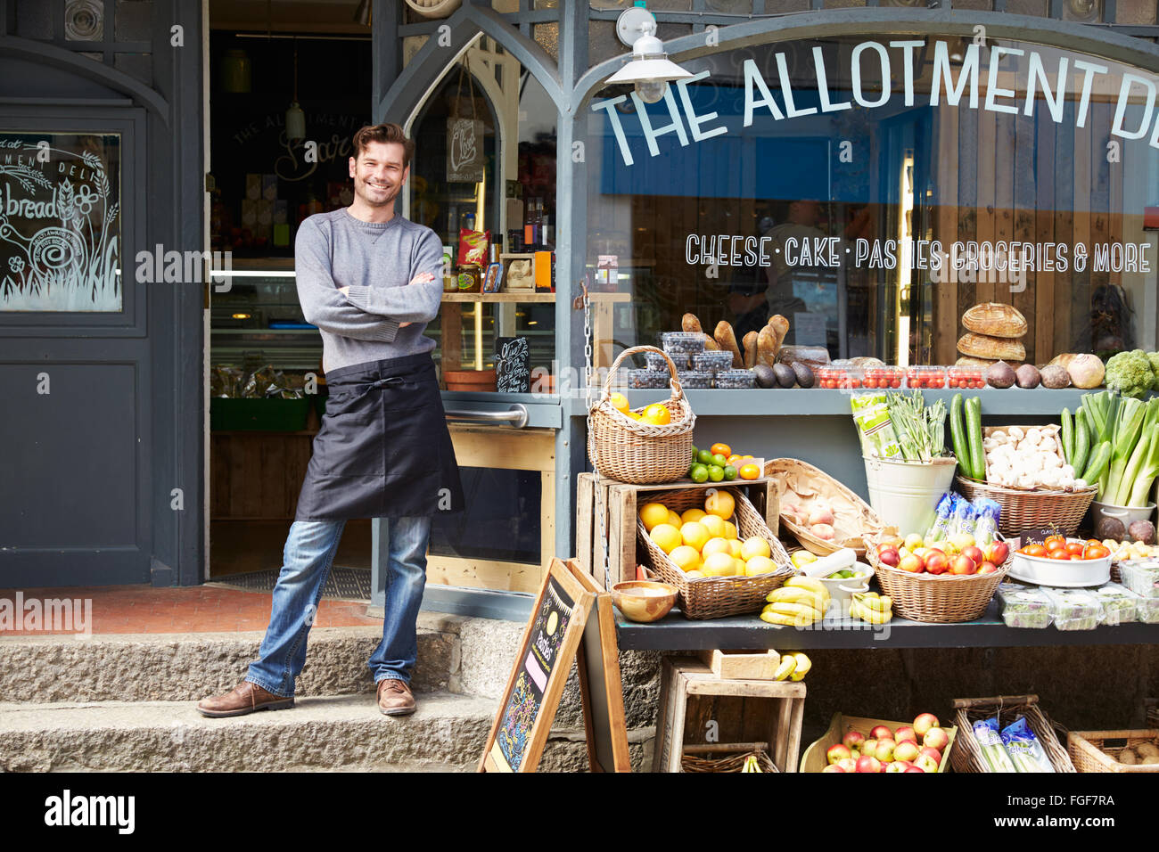 Male Owner Standing Next To Produce Display At Deli Stock Photo - Alamy