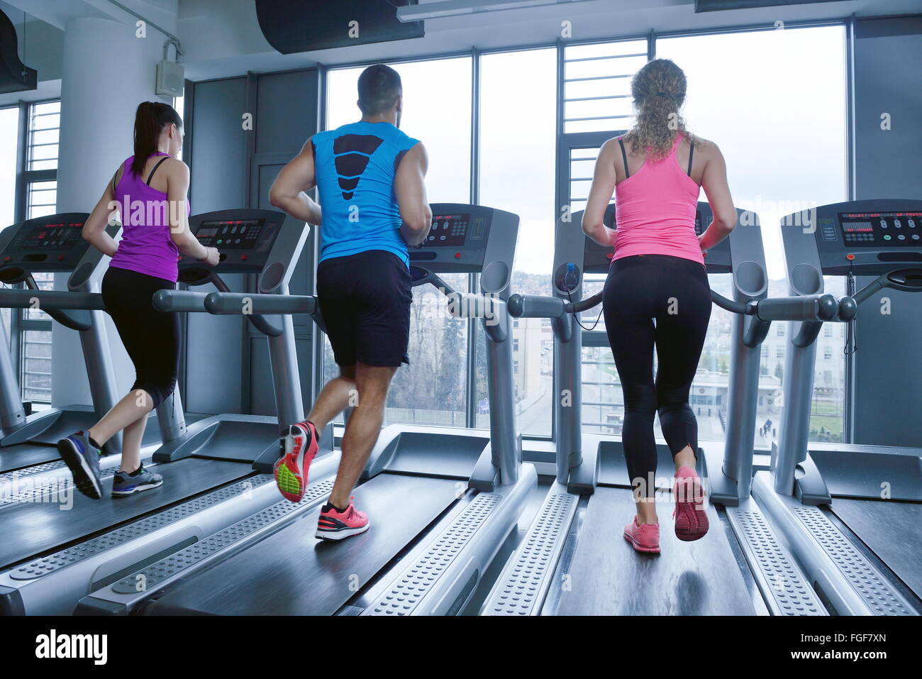 Group of people running on treadmills Stock Photo - Alamy