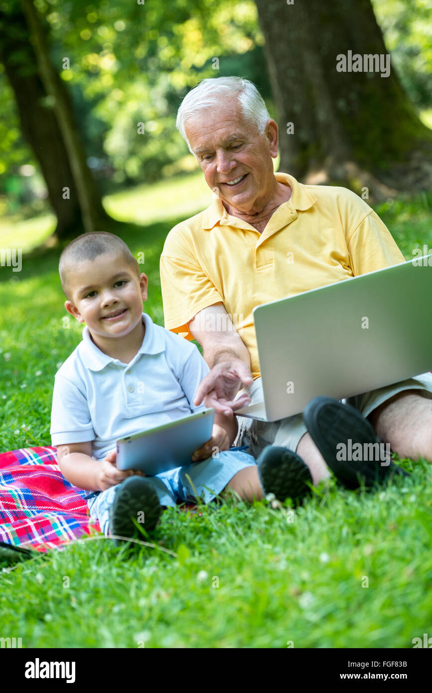 grandfather and child using laptop Stock Photo - Alamy