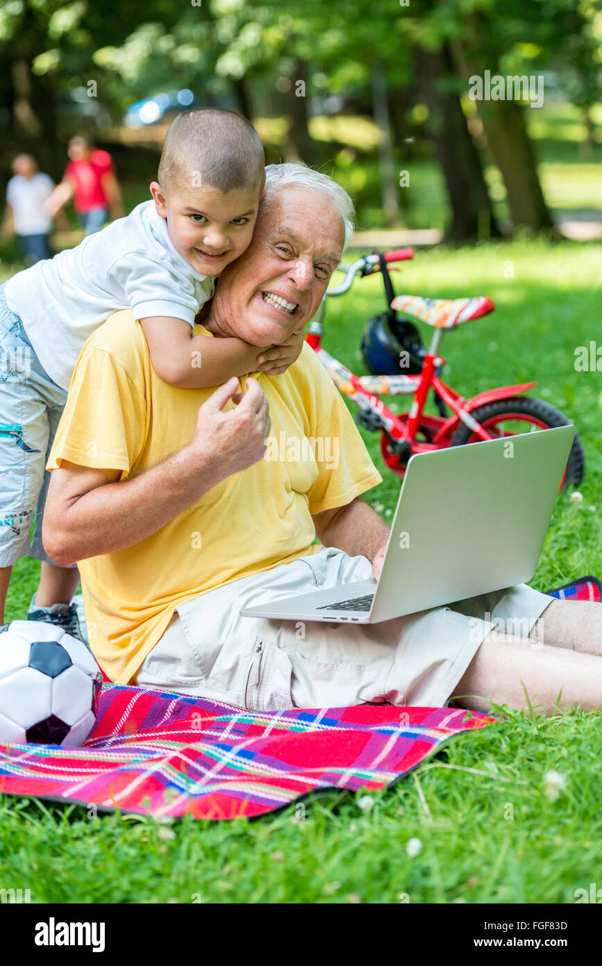 grandfather and child using laptop Stock Photo - Alamy