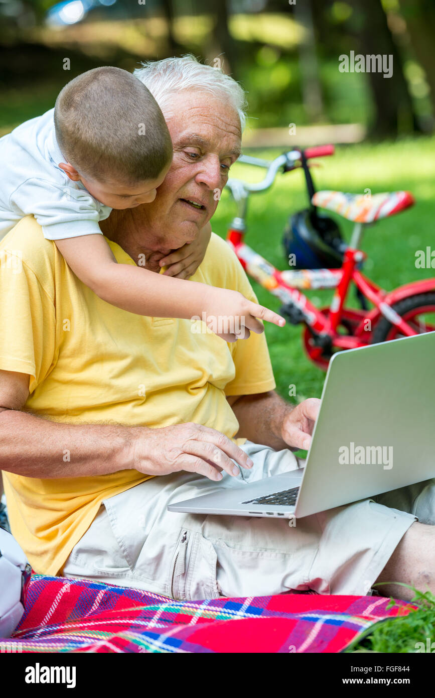 grandfather and child using laptop Stock Photo - Alamy