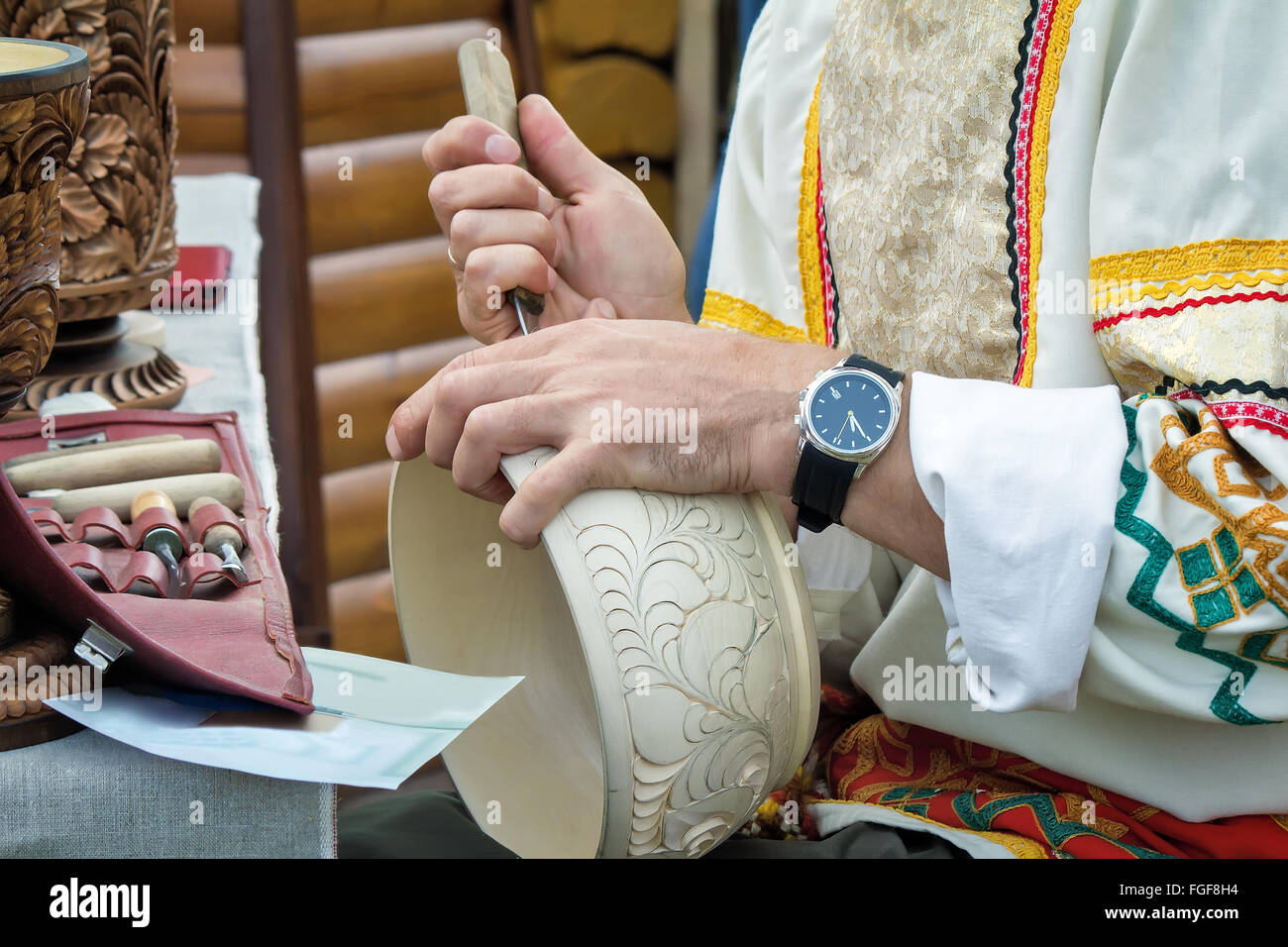 The revival of the ancient craft: man in national costume is decorated ...
