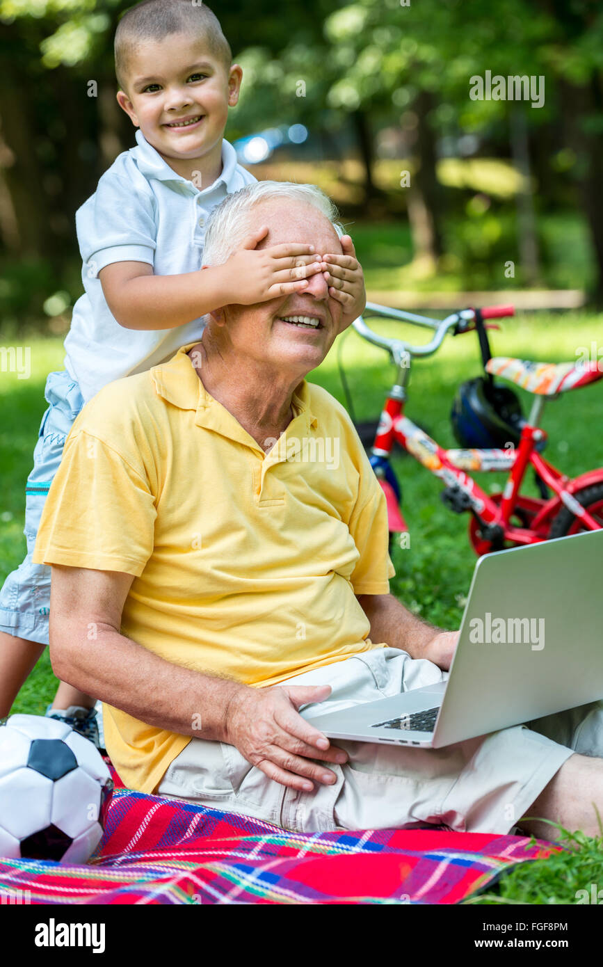 grandfather and child using laptop Stock Photo - Alamy