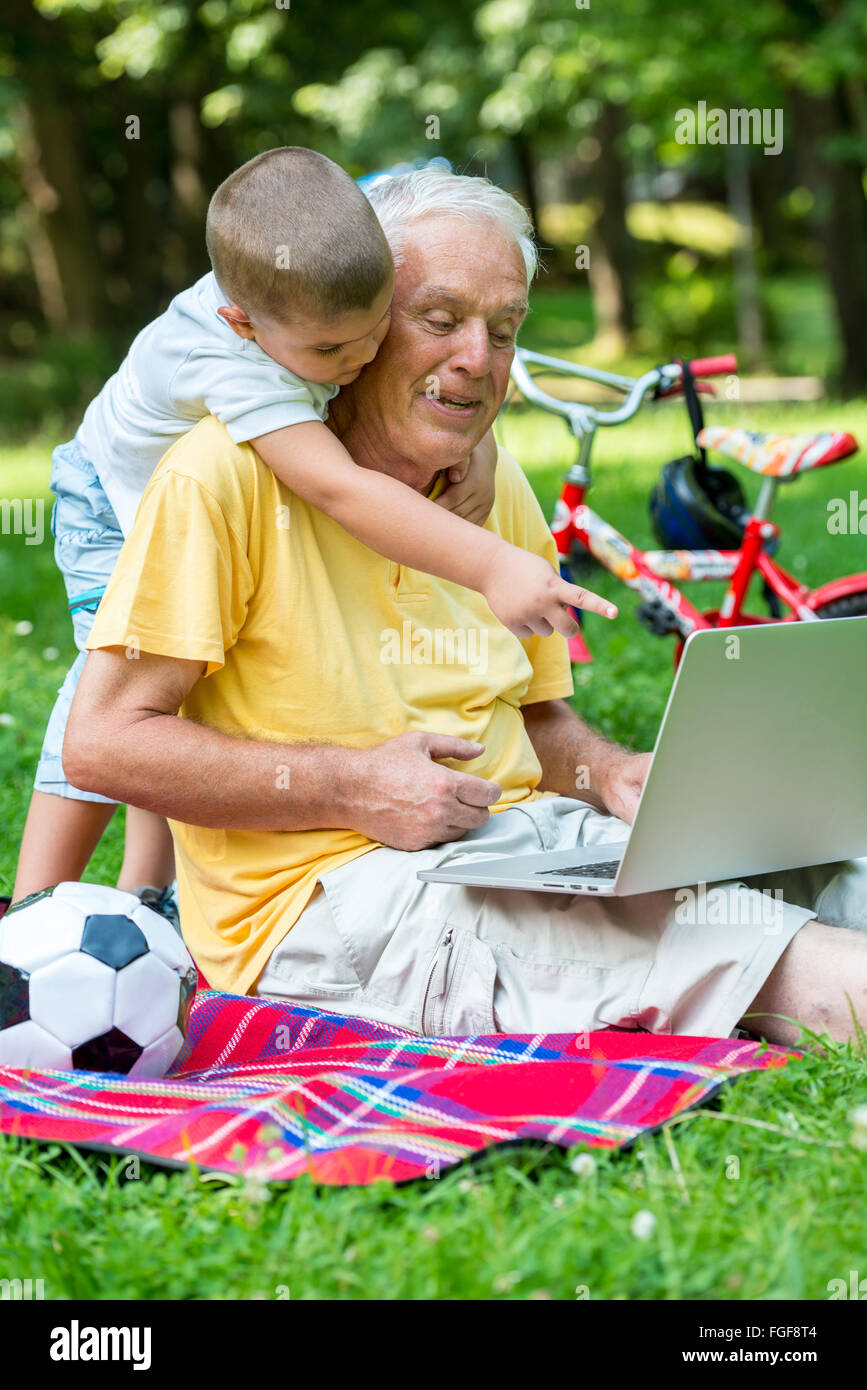 grandfather and child using laptop Stock Photo - Alamy