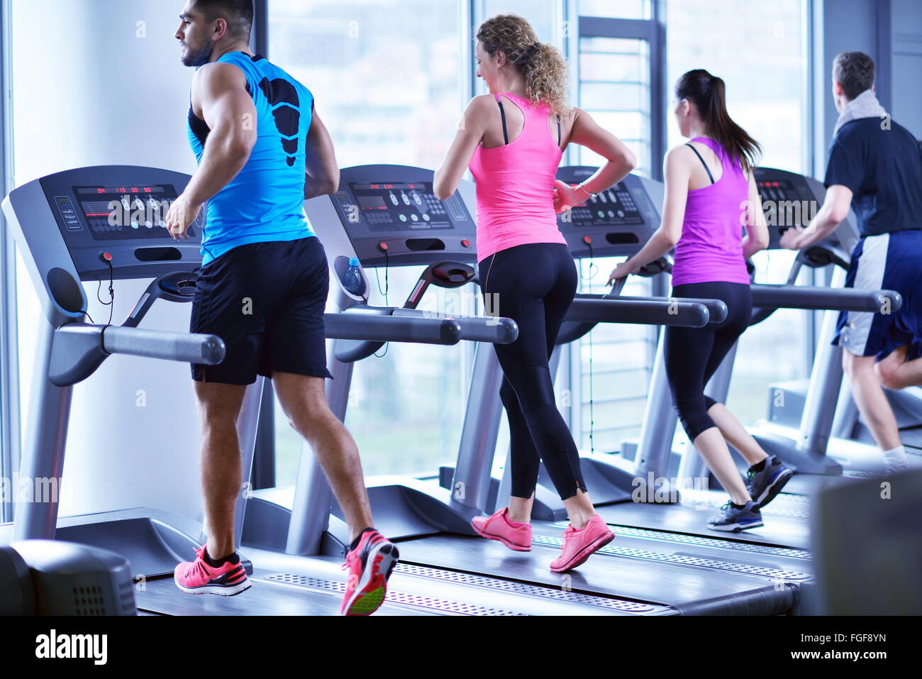 Group of people running on treadmills Stock Photo - Alamy