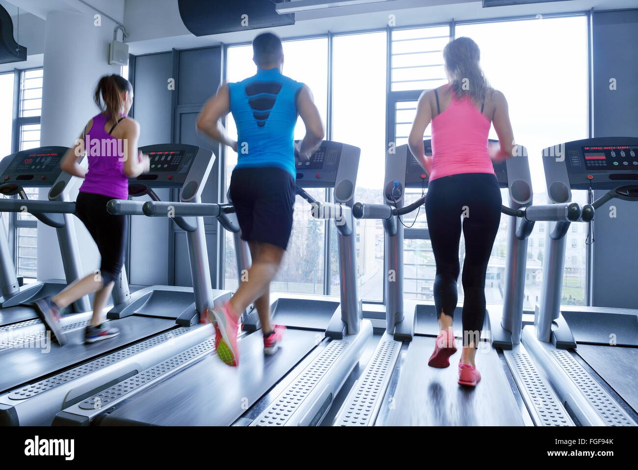 Group of people running on treadmills Stock Photo - Alamy