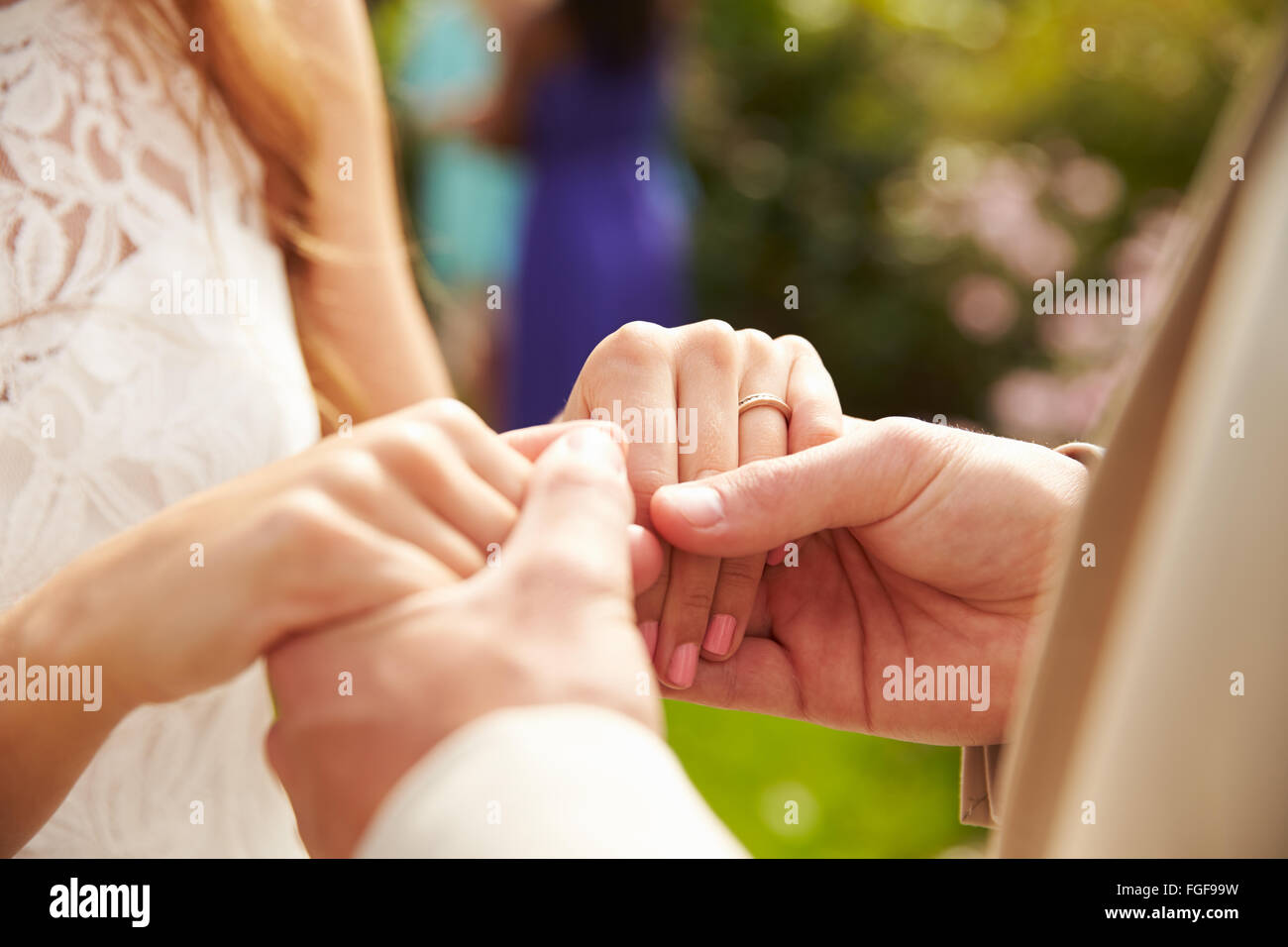 Close Up Of Couple At Wedding Holding Hands Stock Photo - Alamy