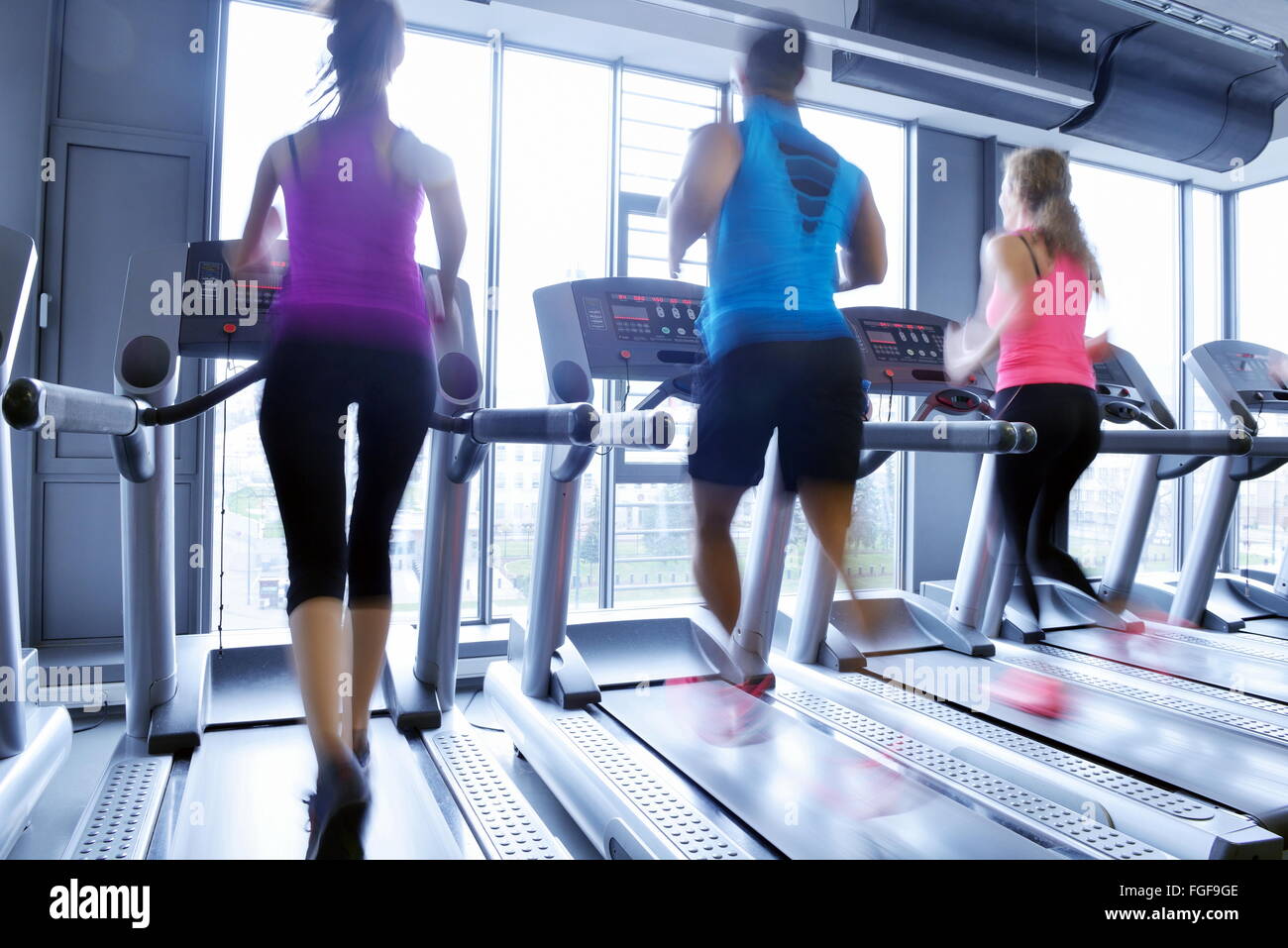 Group of people running on treadmills Stock Photo - Alamy