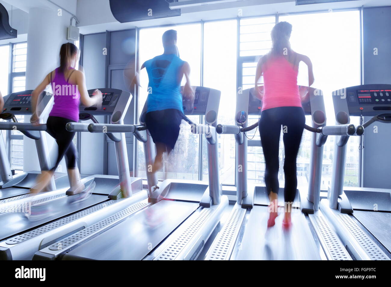Group of people running on treadmills Stock Photo - Alamy