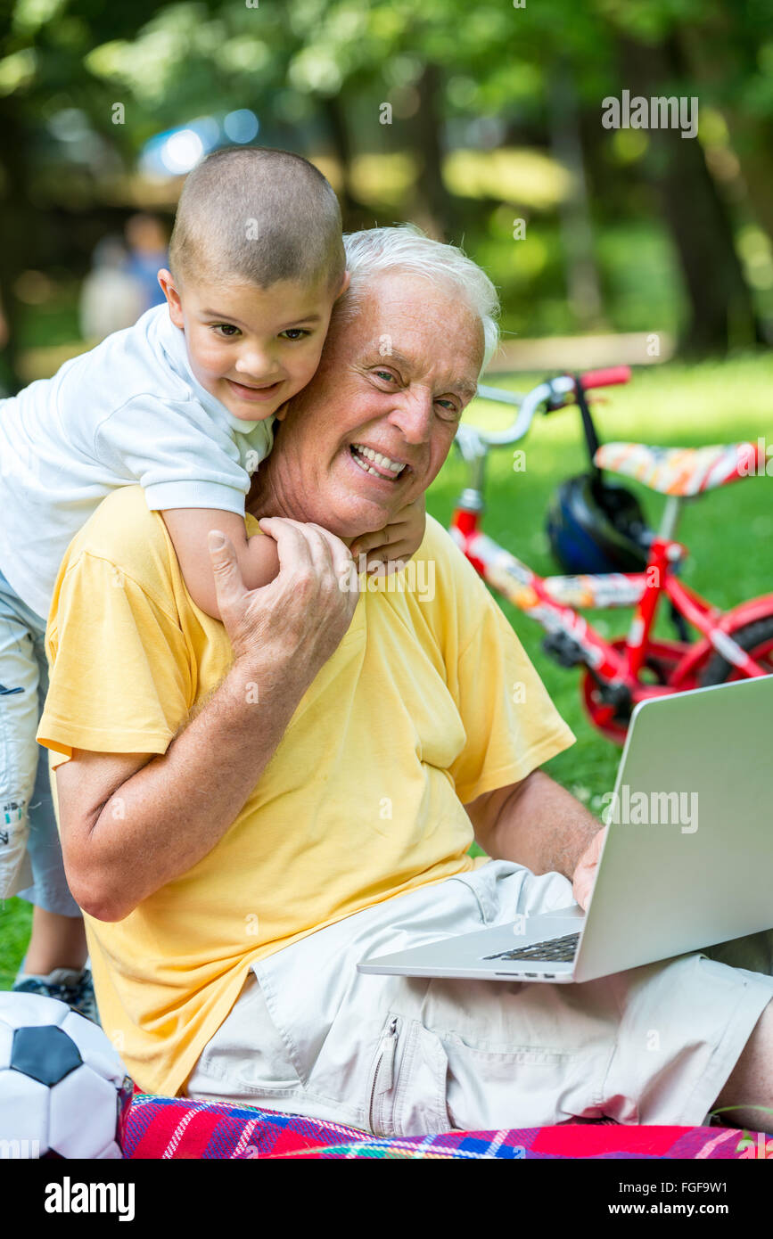 grandfather and child using laptop Stock Photo - Alamy