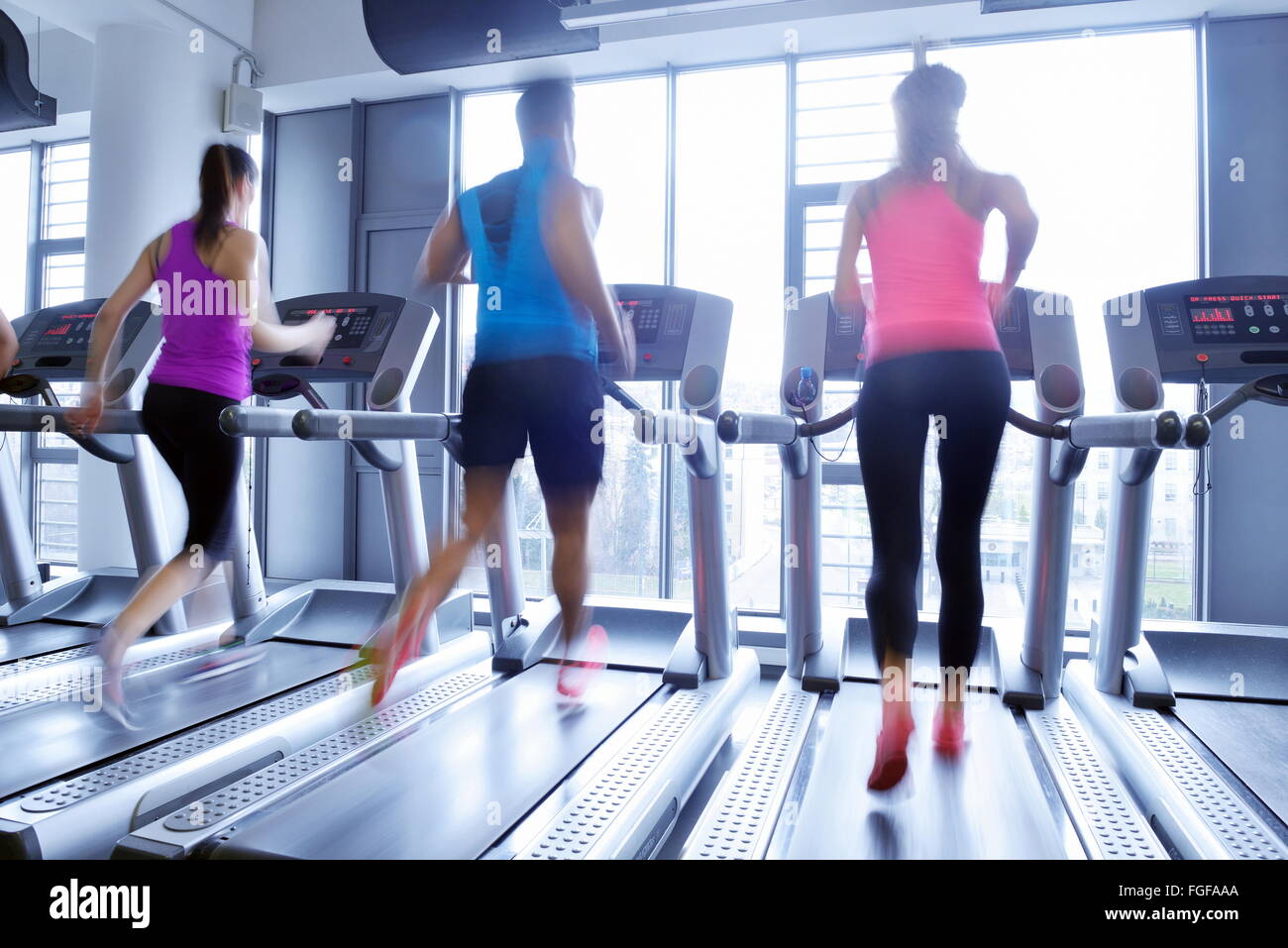 Group of people running on treadmills Stock Photo - Alamy
