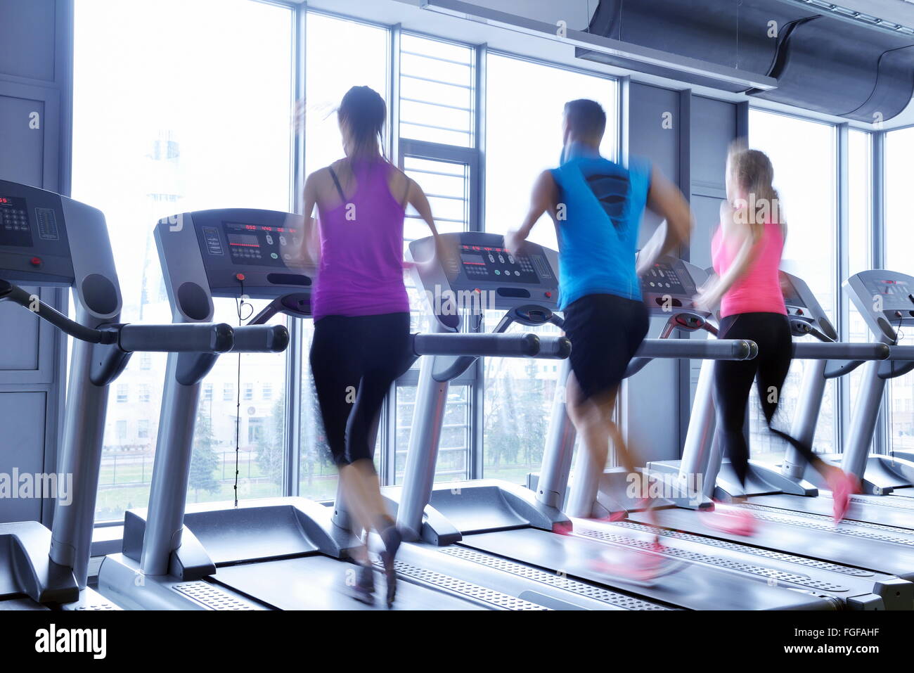 Group of people running on treadmills Stock Photo - Alamy