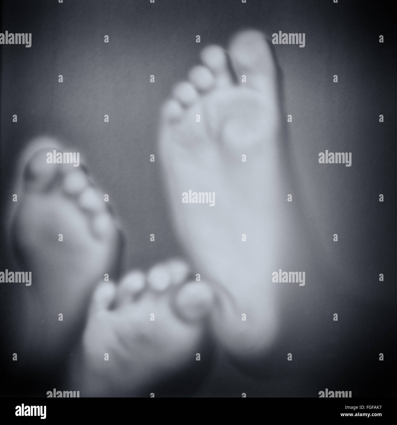 human fet touching glass black and white effect Stock Photo - Alamy