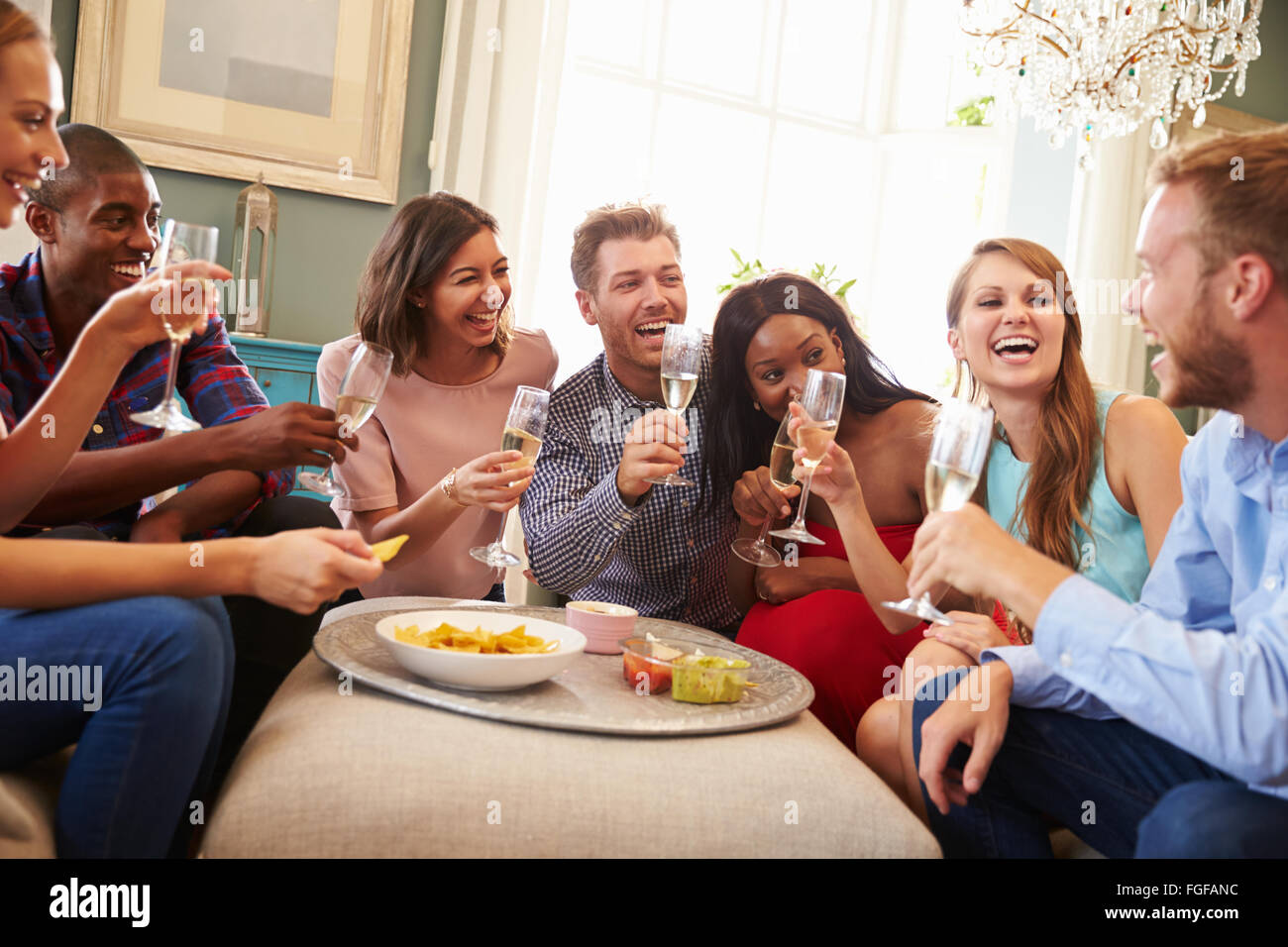 Group Of Friends Celebrating With A Toast At Home Stock Photo - Alamy