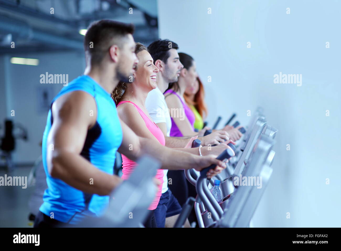 Group of people running on treadmills Stock Photo - Alamy