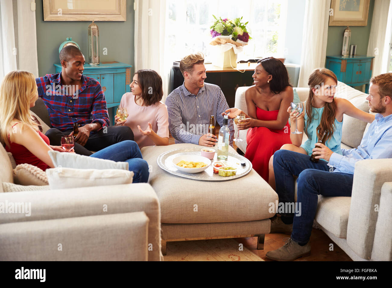 Group Of Friends Relaxing At Home With Drinks Together Stock Photo - Alamy