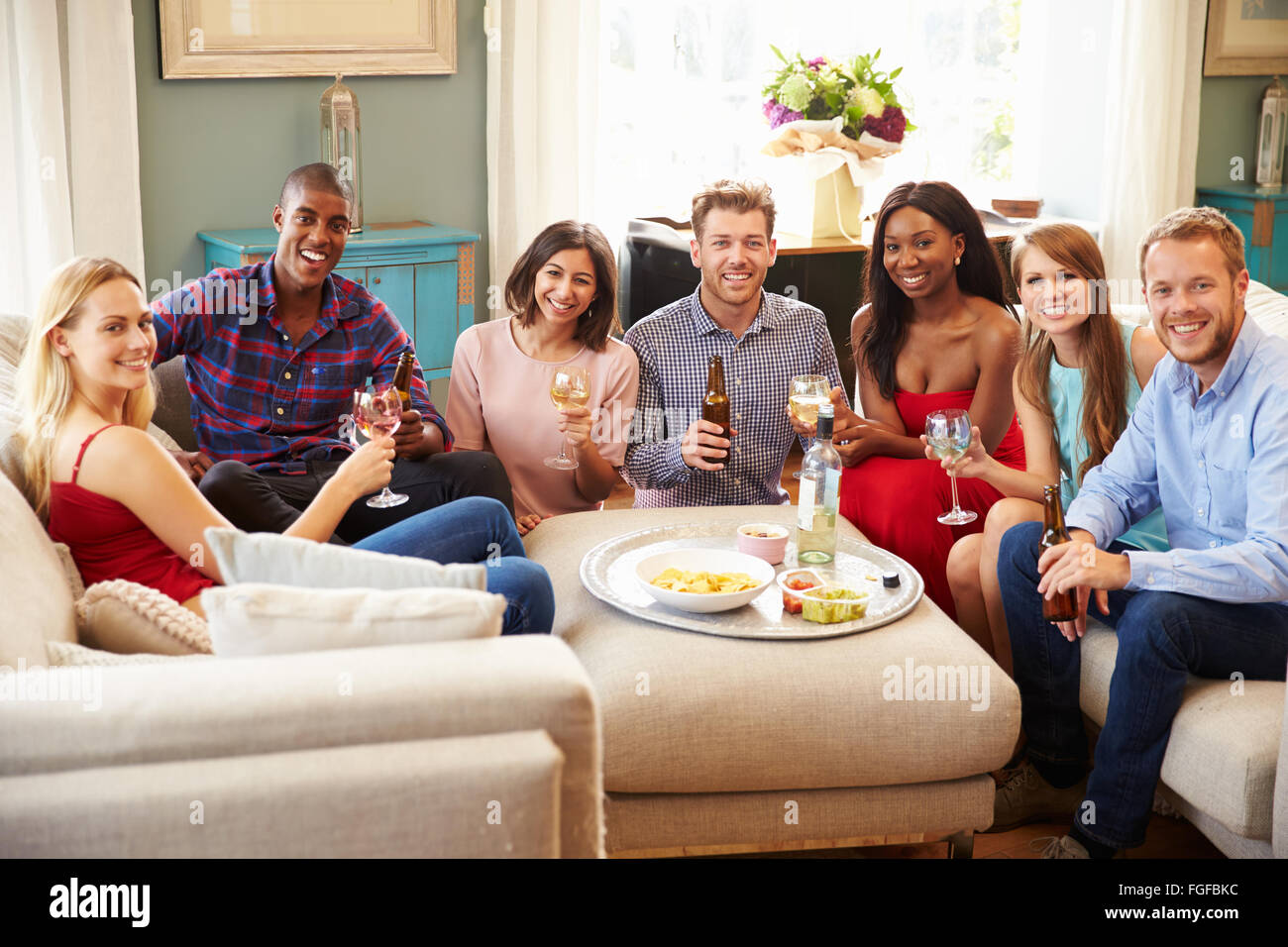Group Of Friends Relaxing At Home With Drinks Together Stock Photo - Alamy