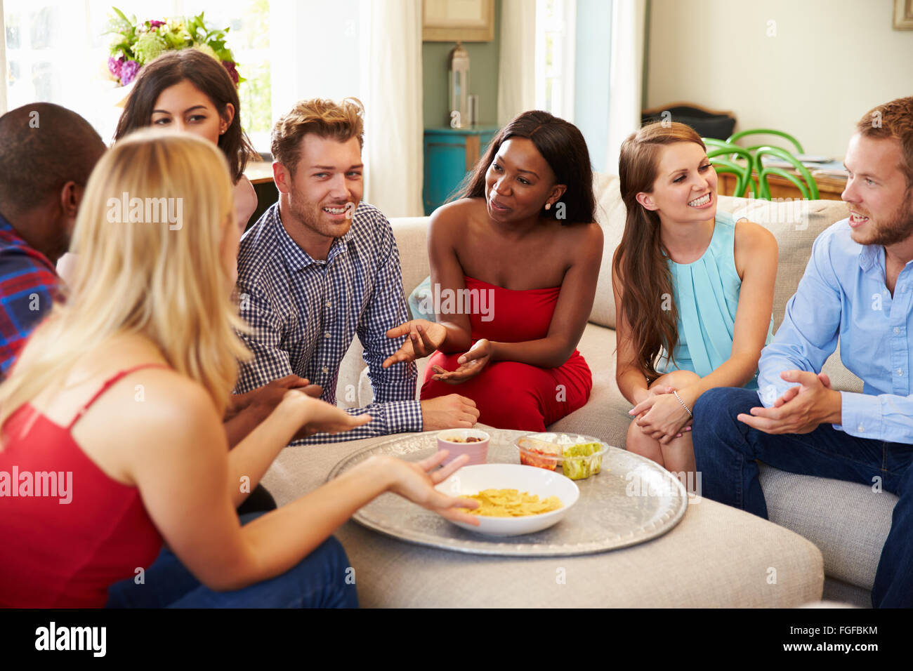 Group Of Friends Relaxing At Home On Sofa Together Stock Photo - Alamy