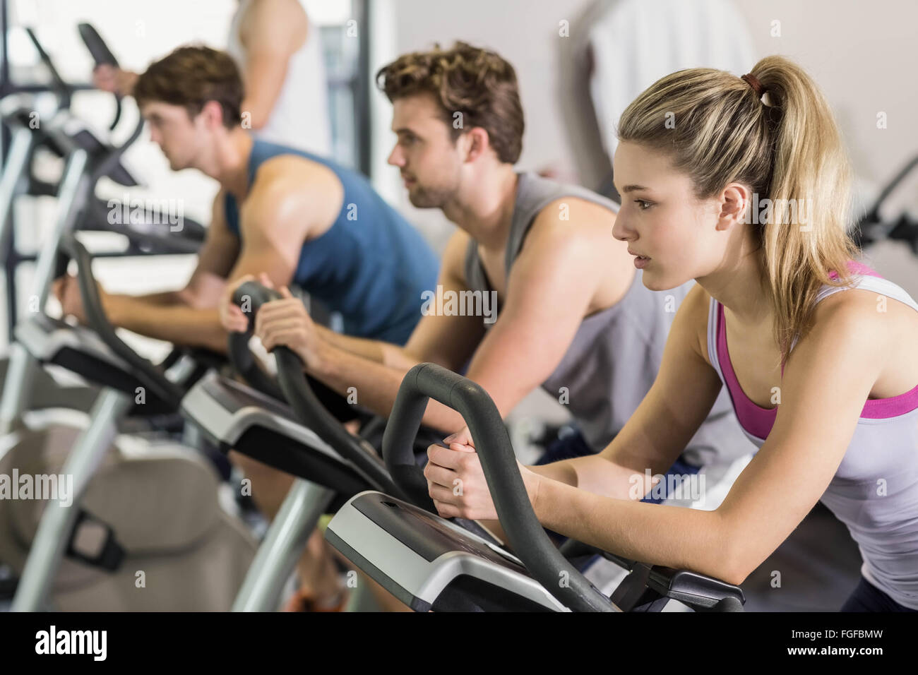Fit people doing exercise bike Stock Photo - Alamy