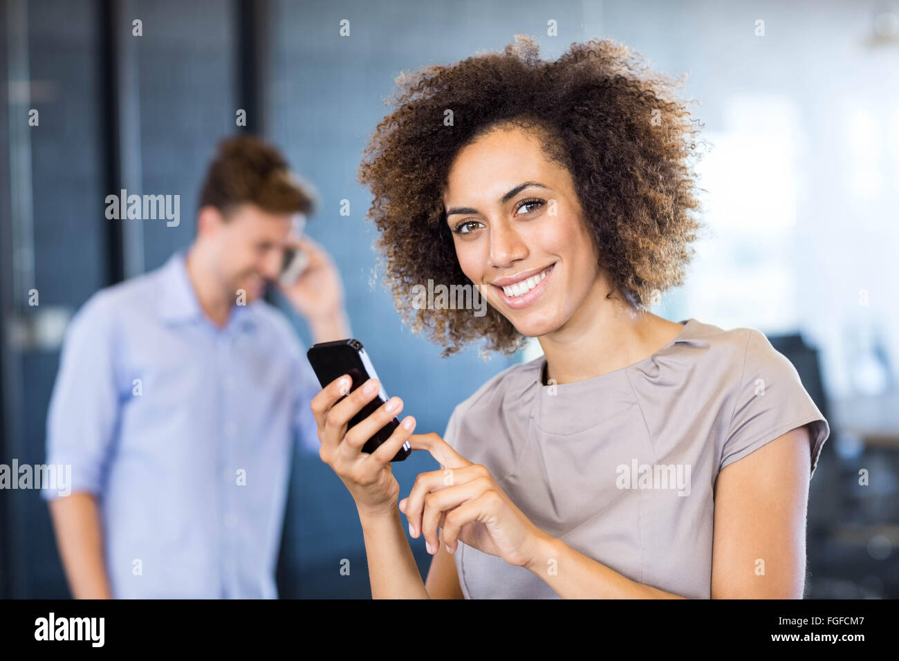 Colleagues communicating on mobile phone Stock Photo - Alamy