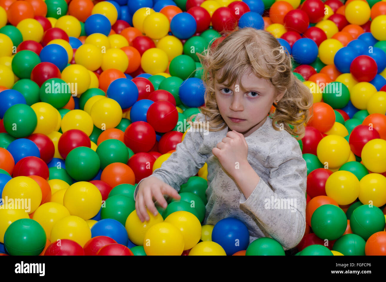 happy blond child girl playing with colorful balls Stock Photo - Alamy