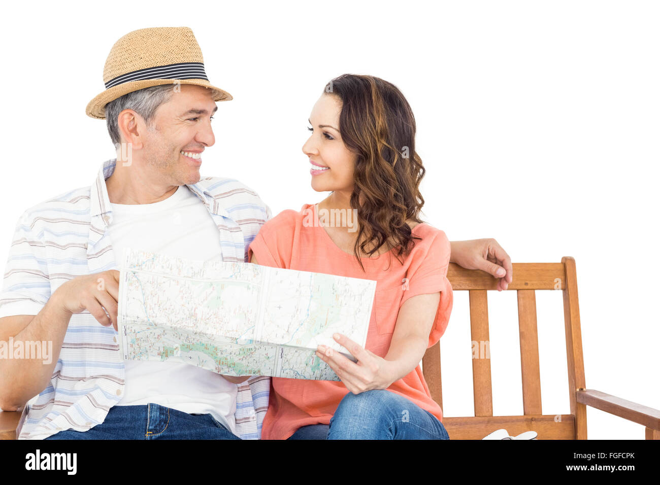 Couple on bench looking at map Stock Photo - Alamy