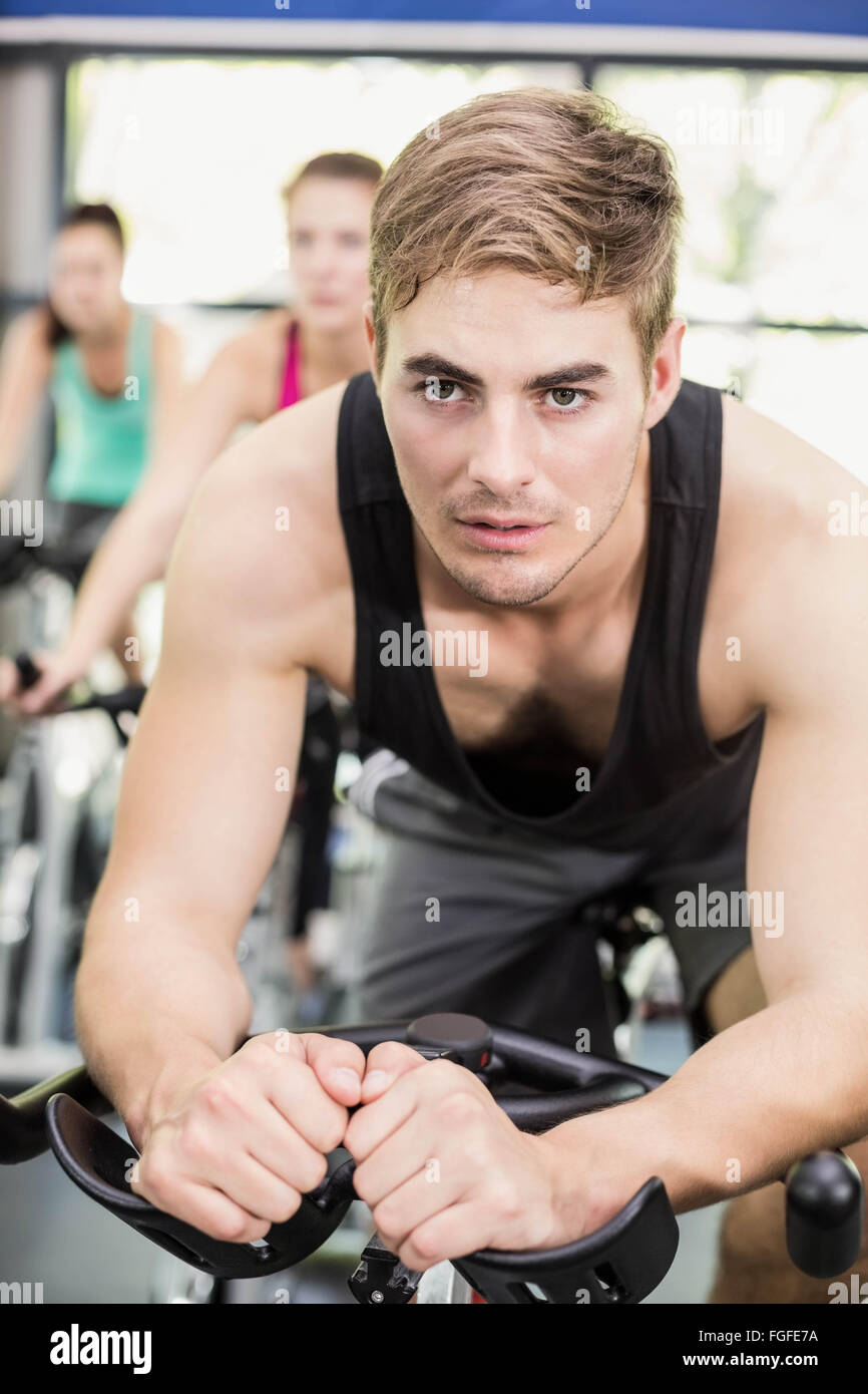 Fit group of people using exercise bike together Stock Photo - Alamy