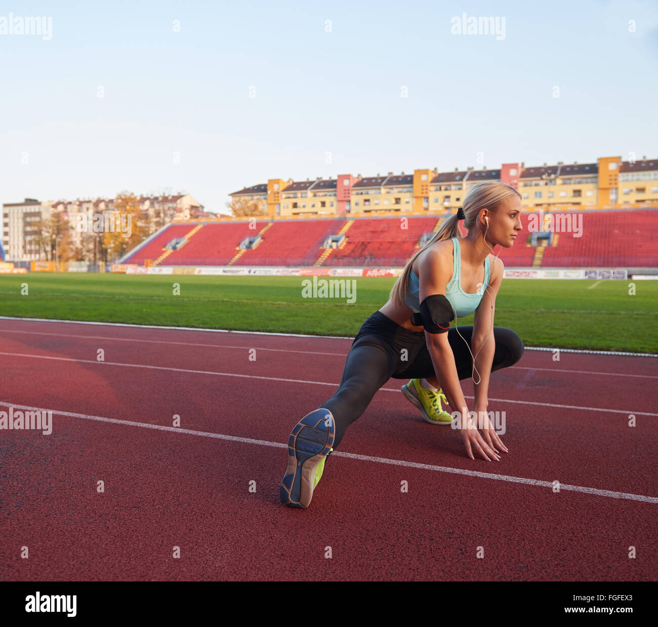 sporty woman on athletic race track Stock Photo - Alamy