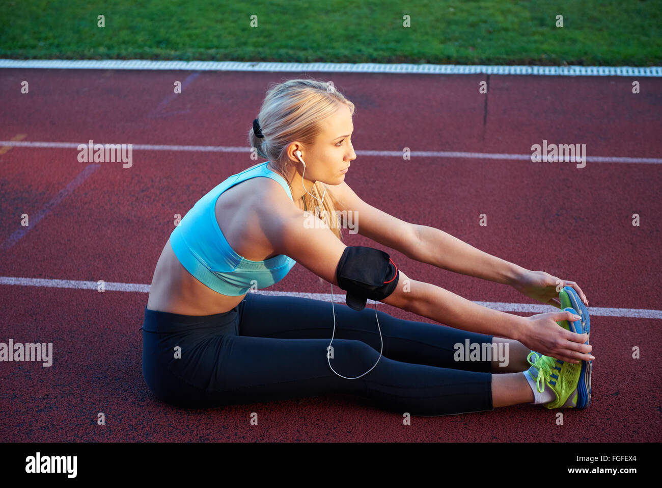 sporty woman on athletic race track Stock Photo - Alamy