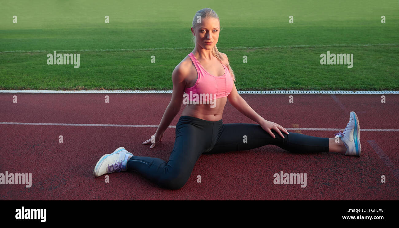 sporty woman on athletic race track Stock Photo - Alamy