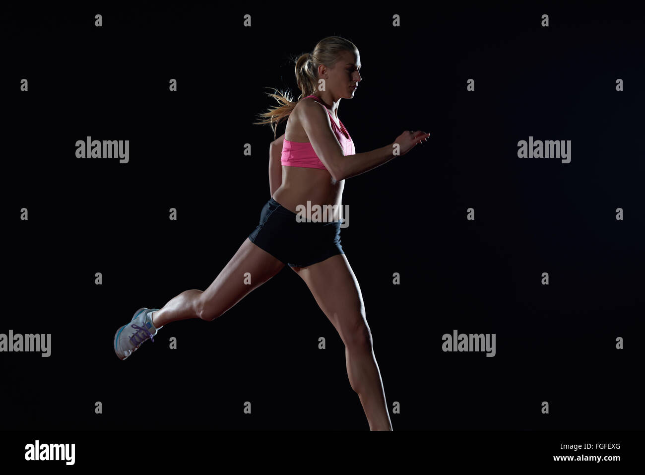 Athletic woman running on track Stock Photo - Alamy