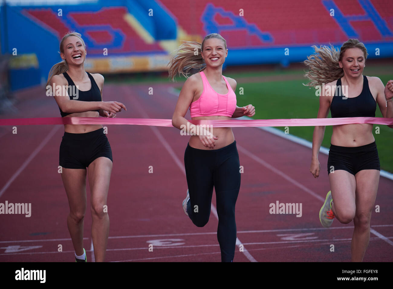 Female Runners Finishing Race Together Stock Photo - Alamy