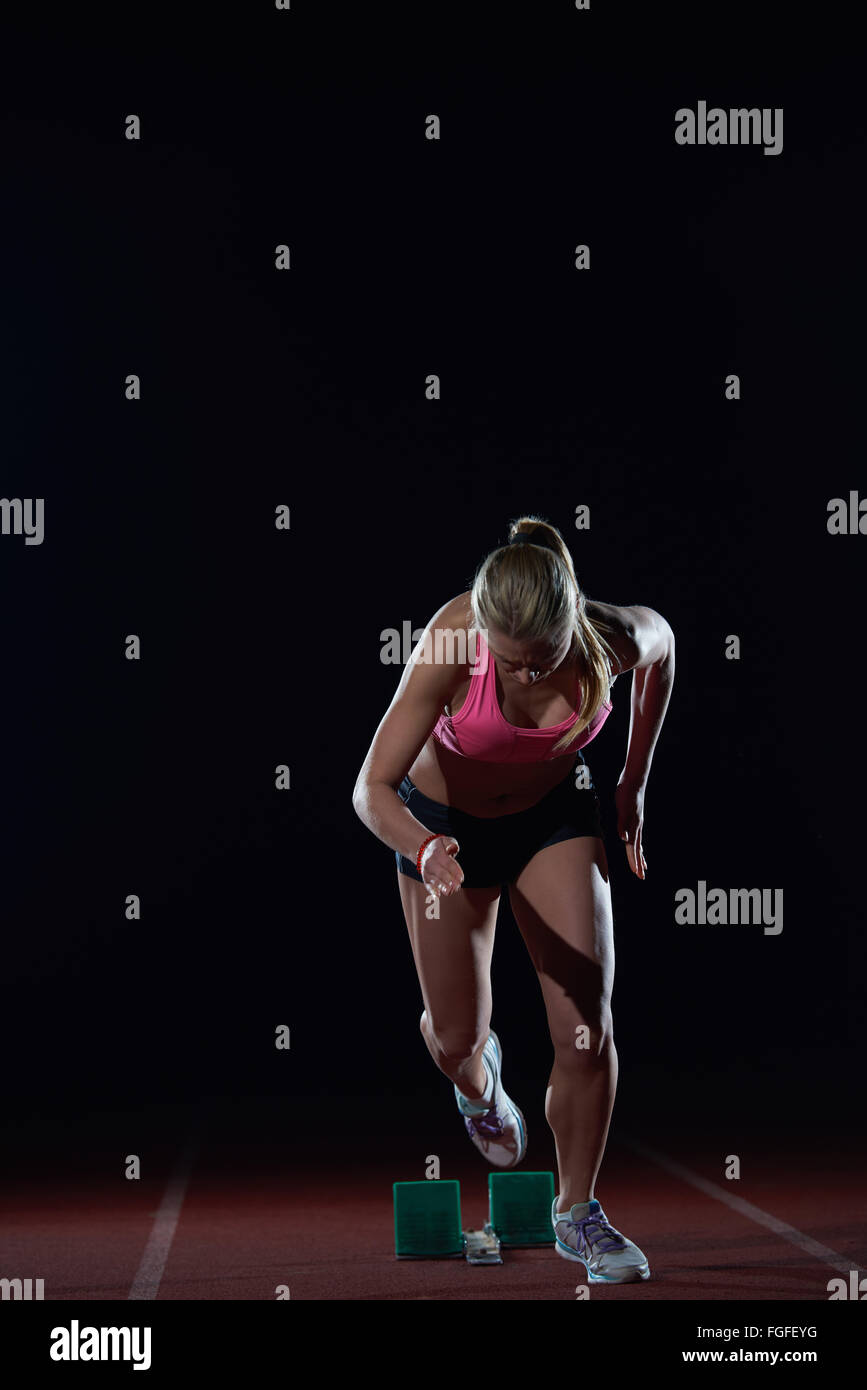 woman sprinter leaving starting blocks Stock Photo - Alamy