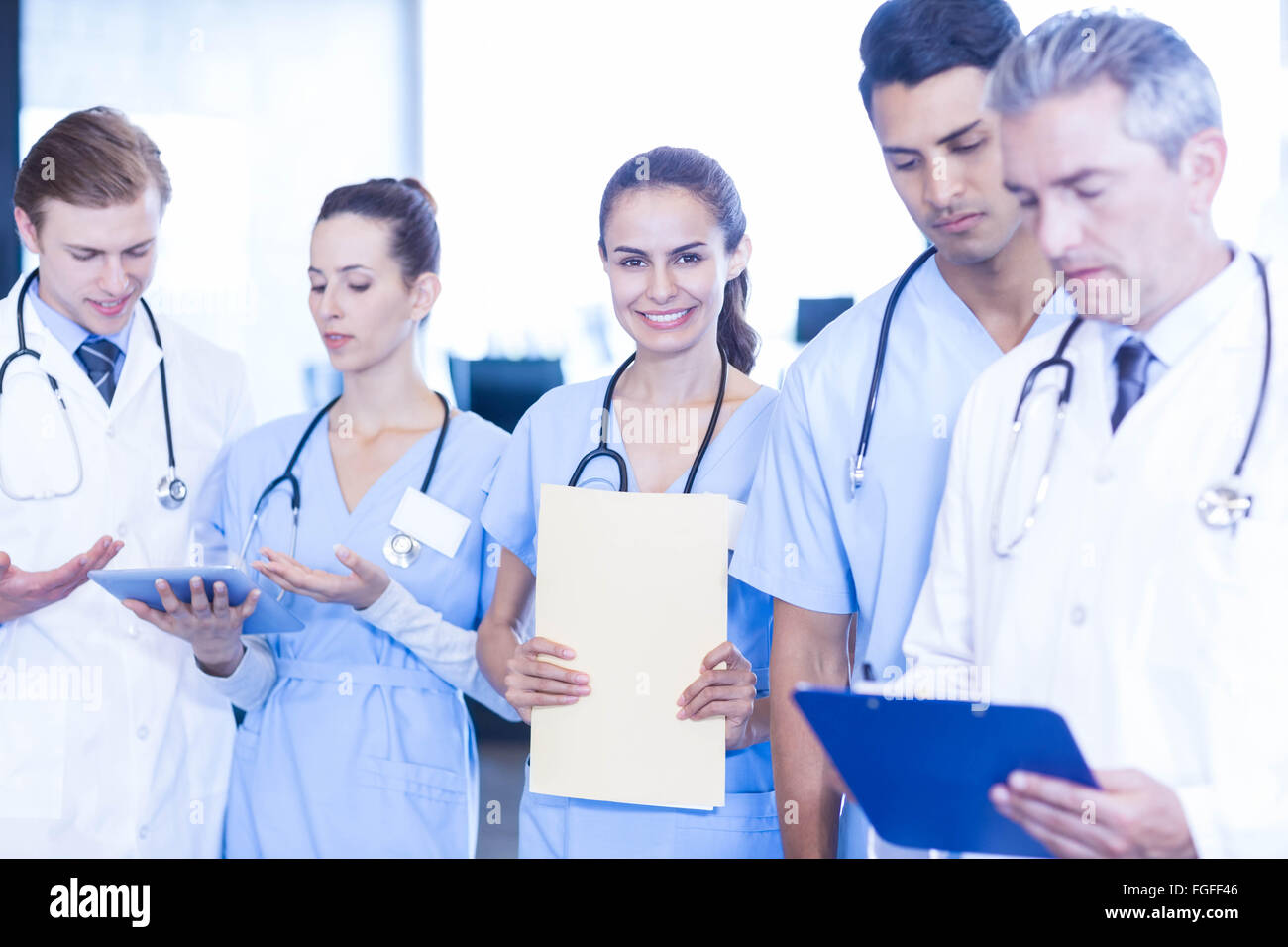 Doctors examining medical report Stock Photo - Alamy