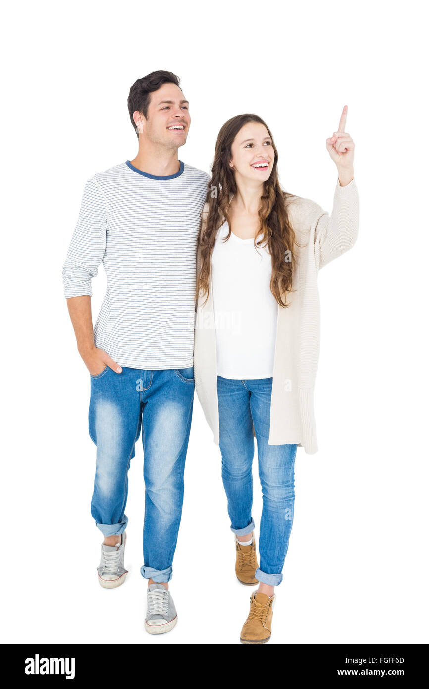 Smiling couple pointing away Stock Photo - Alamy
