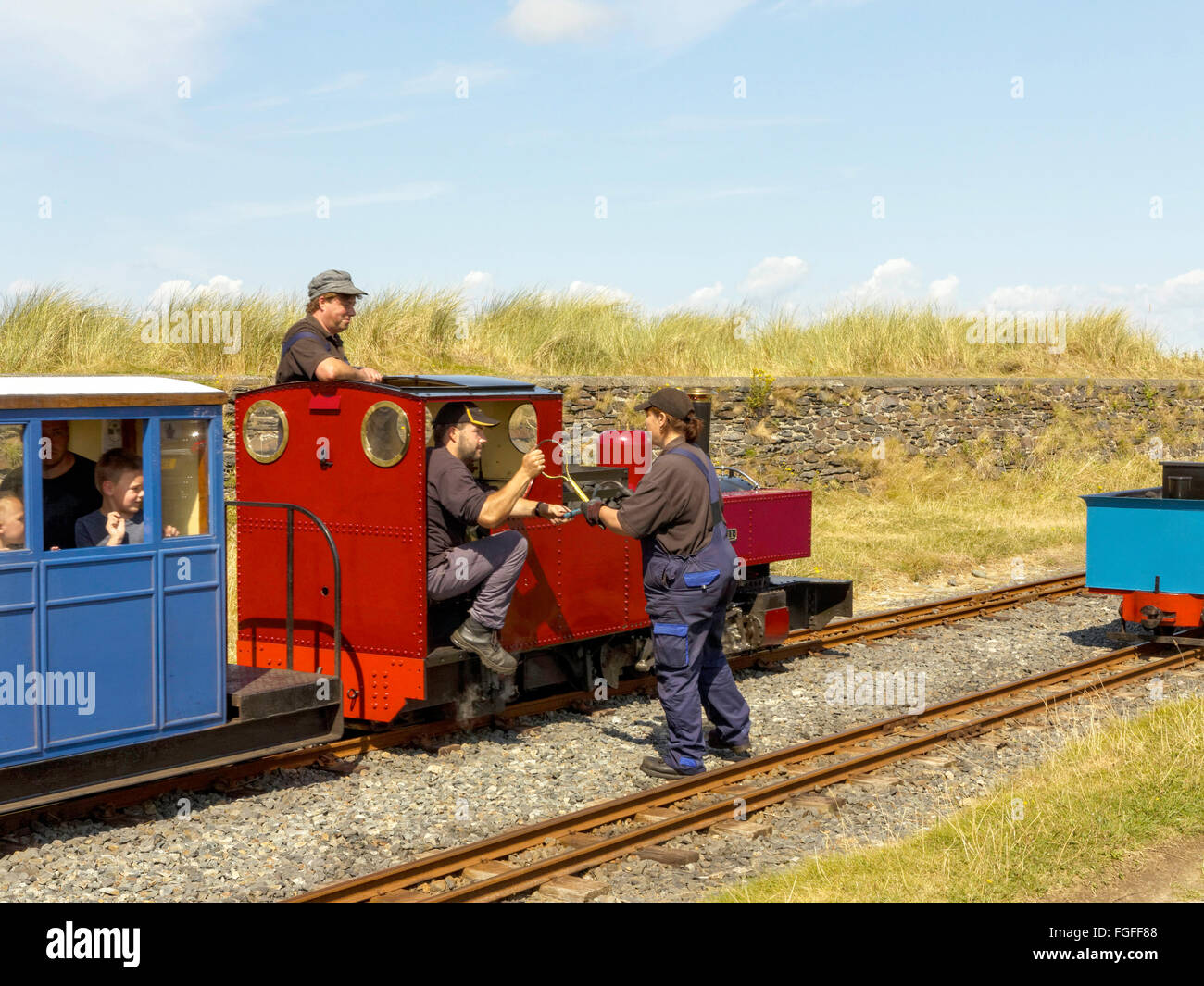 Two steam engine drivers of a narrow gauge seaside railway exchange ...