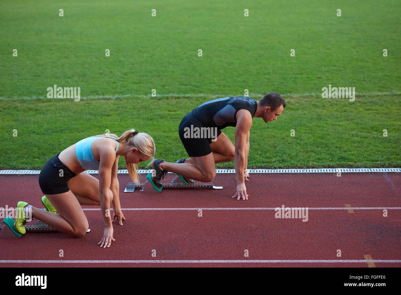 athlete woman group running on athletics race track Stock Photo - Alamy