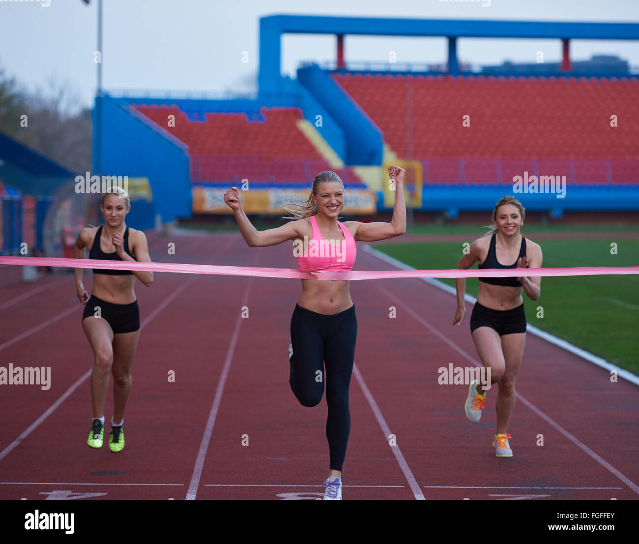 Female Runners Finishing Race Together Stock Photo - Alamy