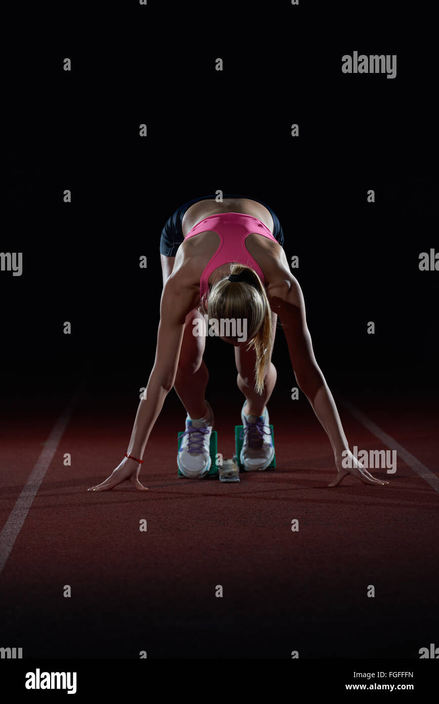 woman sprinter leaving starting blocks Stock Photo - Alamy