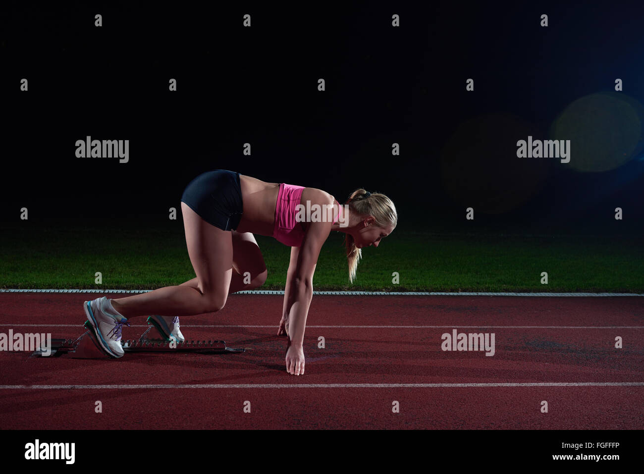 woman sprinter leaving starting blocks Stock Photo - Alamy