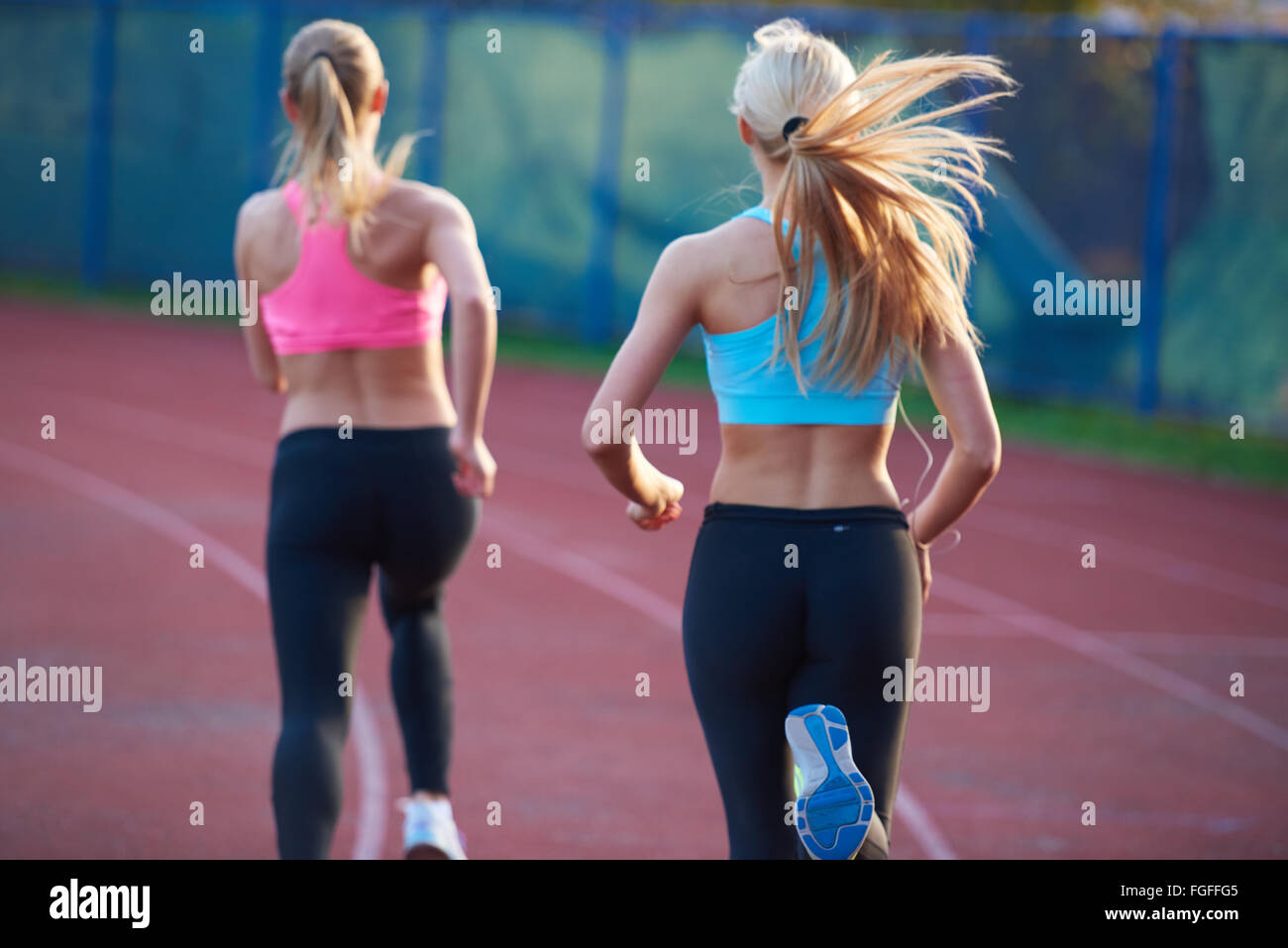 athlete woman group running on athletics race track Stock Photo - Alamy