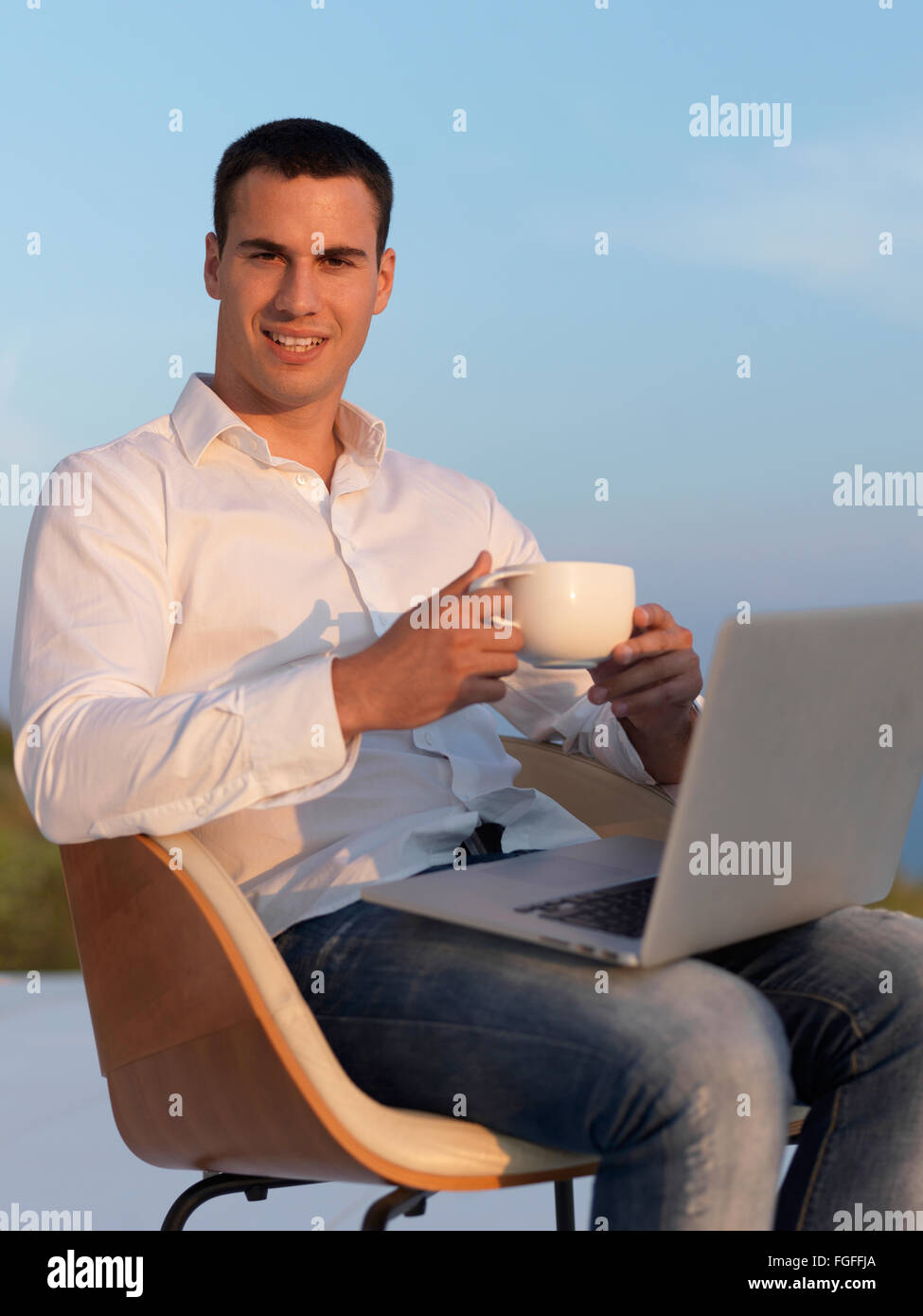 relaxed young man at home on balcony Stock Photo - Alamy