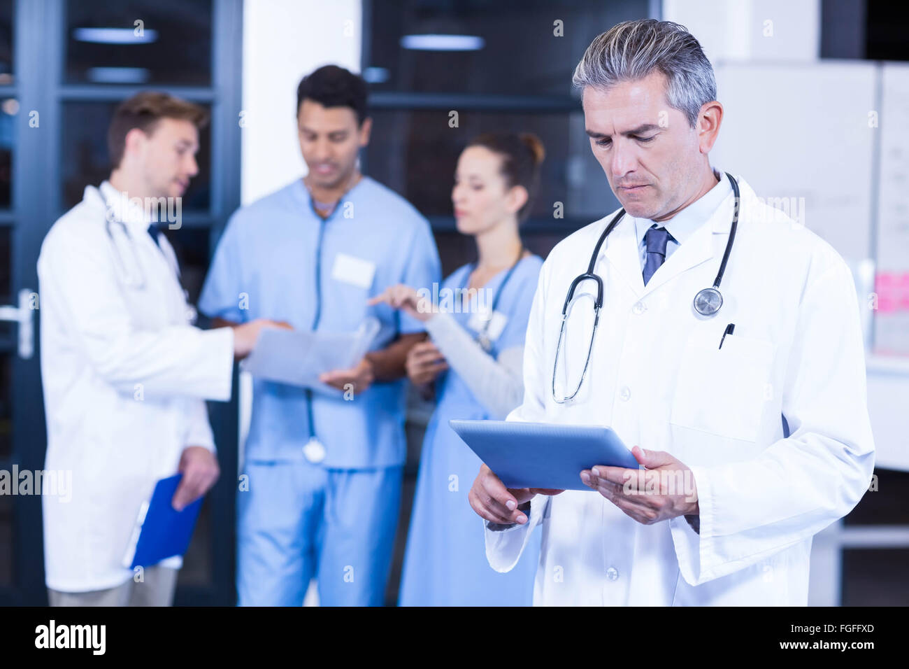 Doctor using tablet in hospital Stock Photo - Alamy