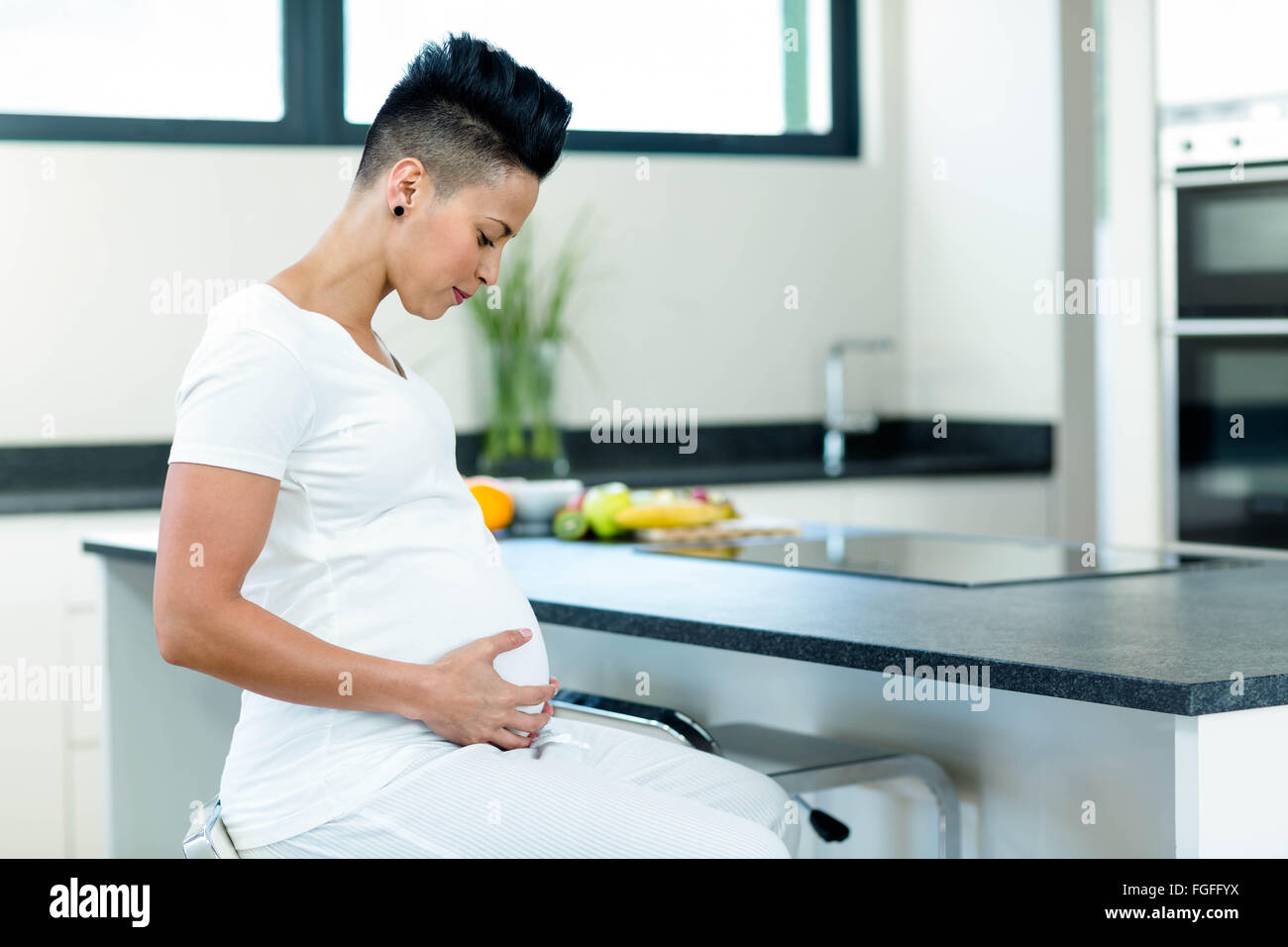 Pregnant woman sitting on kitchen hi-res stock photography and images ...