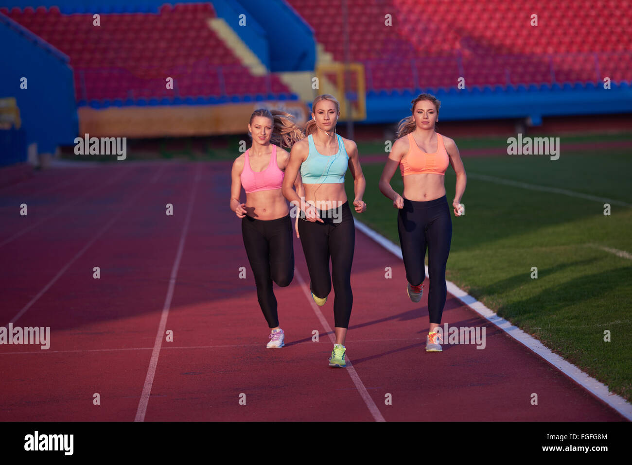 athlete woman group running on athletics race track Stock Photo - Alamy