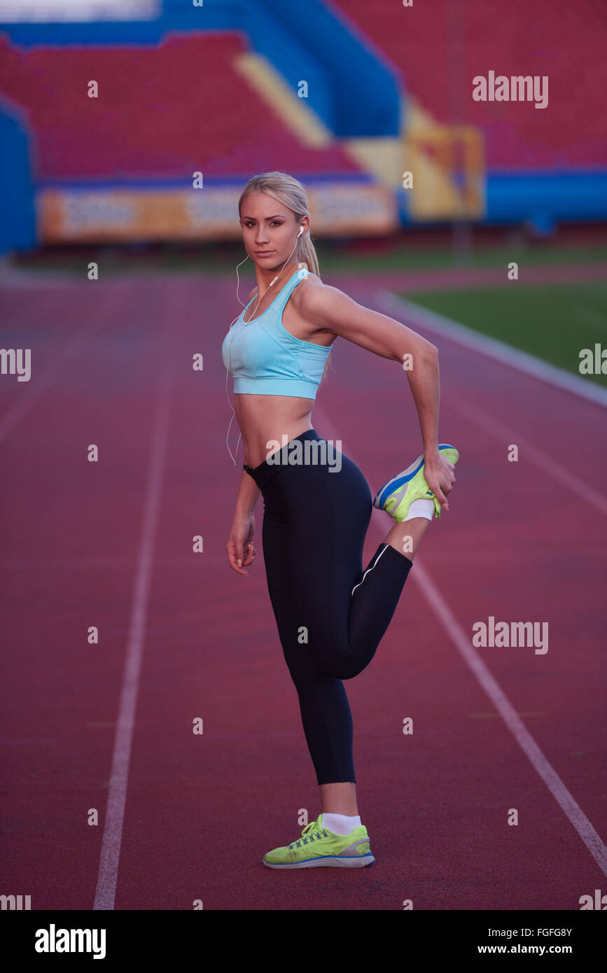 sporty woman on athletic race track Stock Photo - Alamy